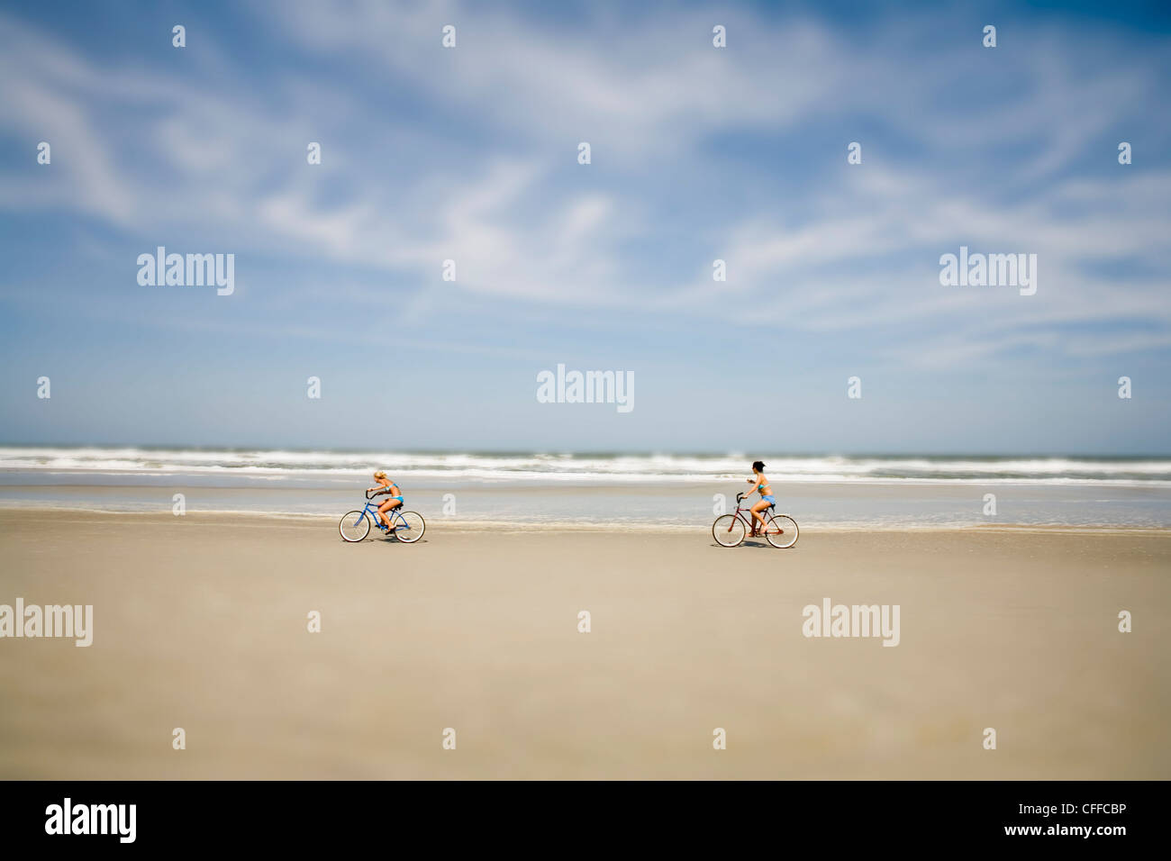 Women Biking on Beach Stock Photo - Alamy