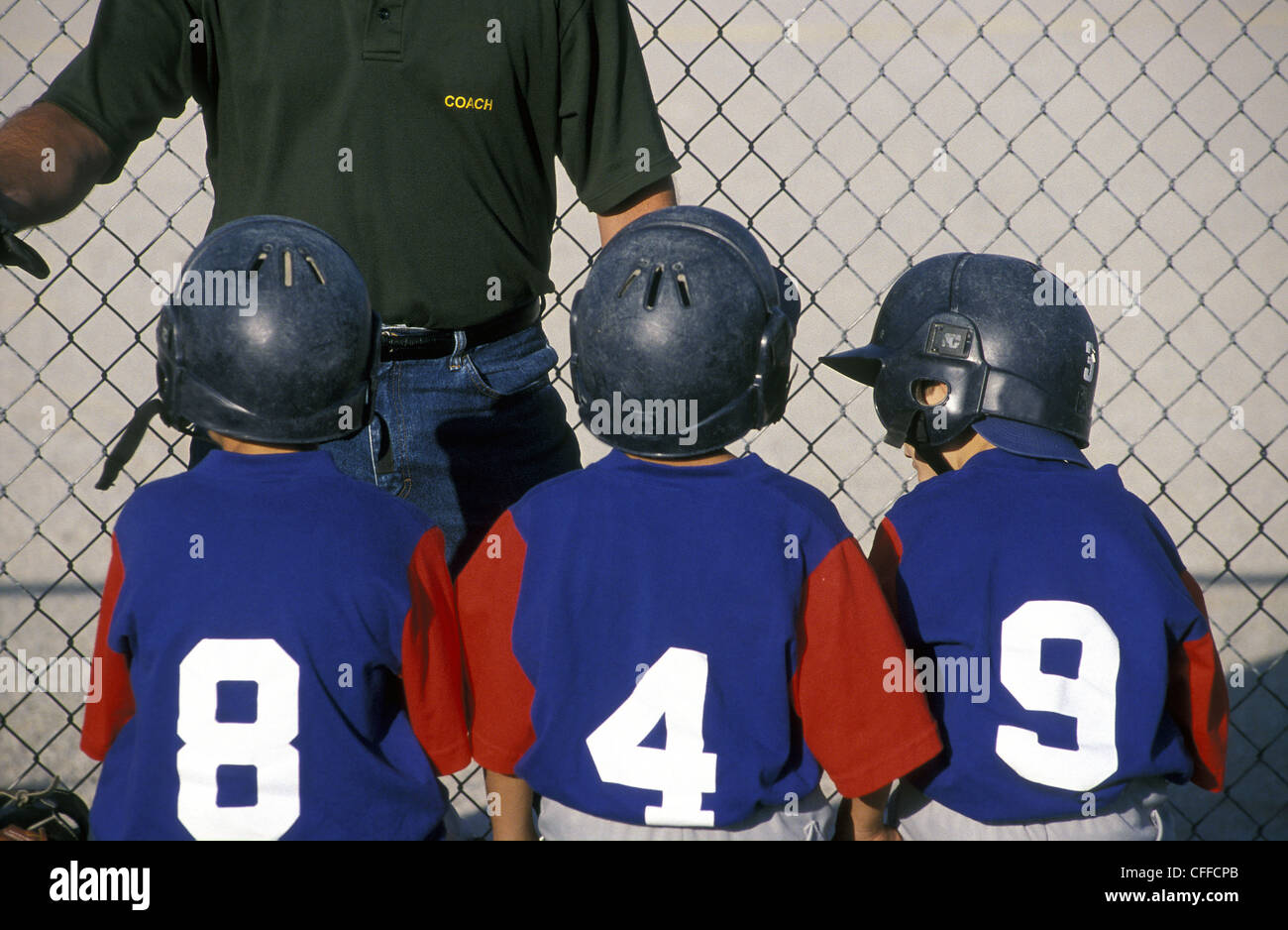 Children at Baseball Game Listening to Coach Stock Photo - Alamy