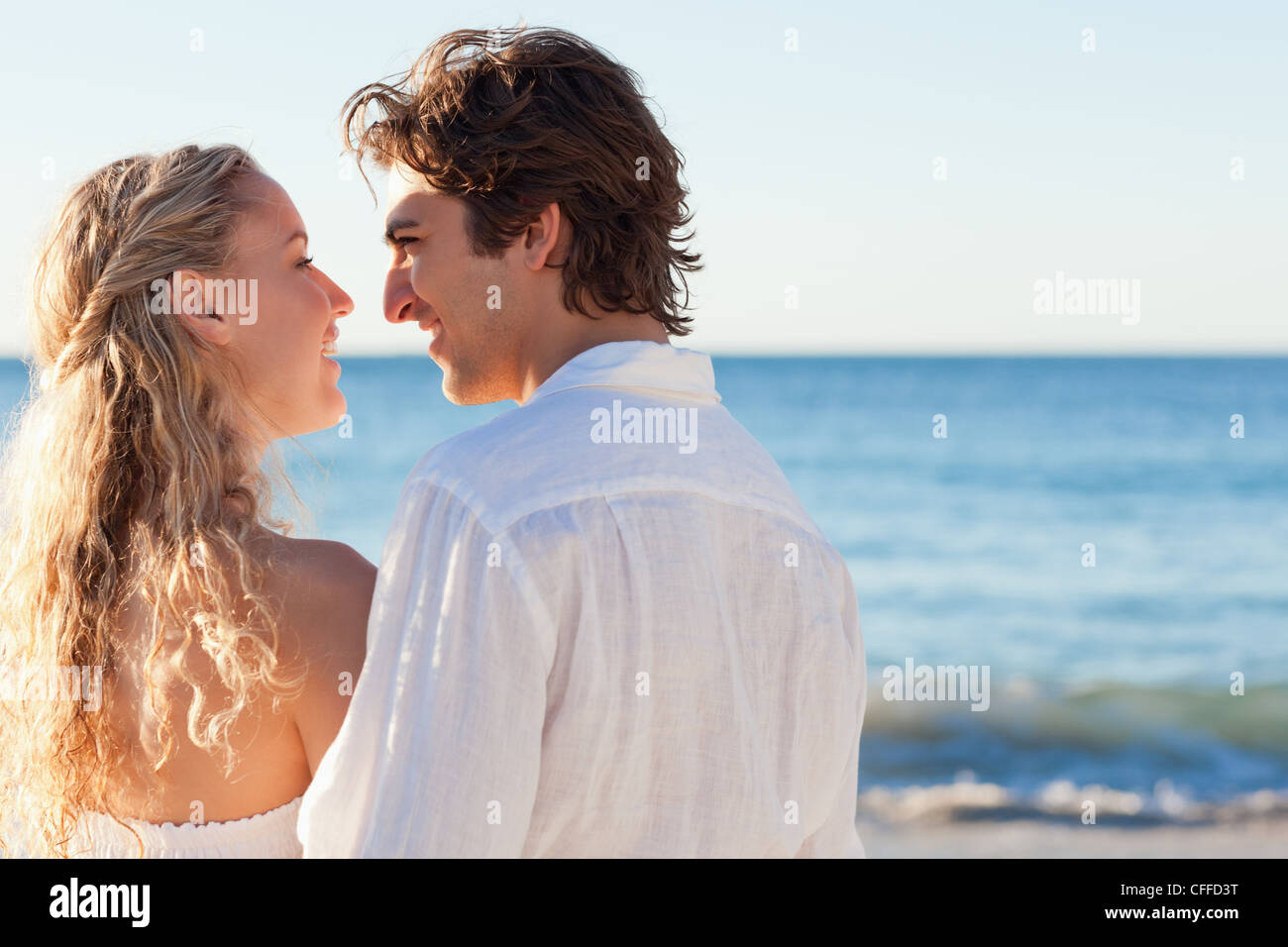 Back view of couple at the seaside Stock Photo - Alamy