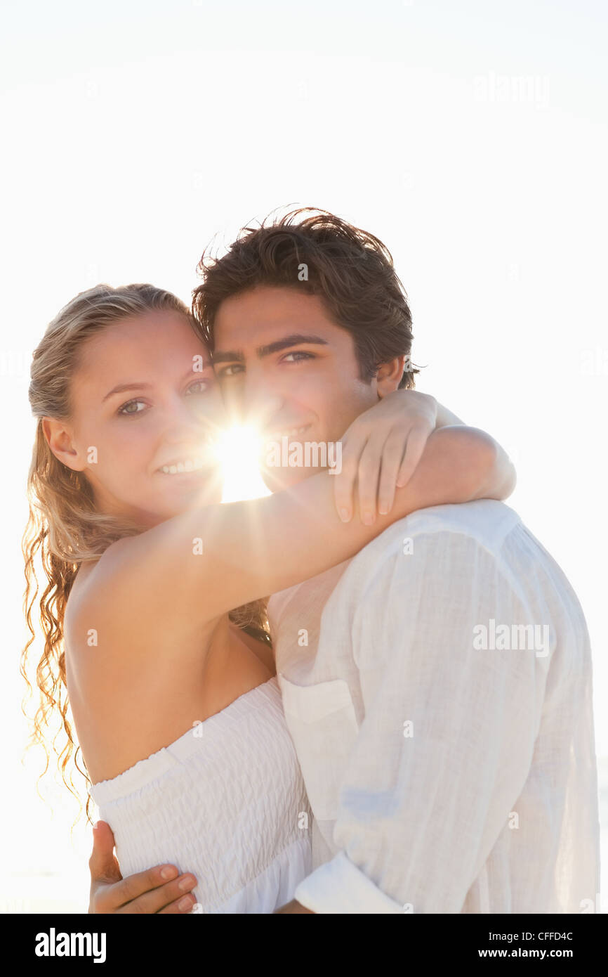 Side view of an embracing couple against the sunset Stock Photo - Alamy