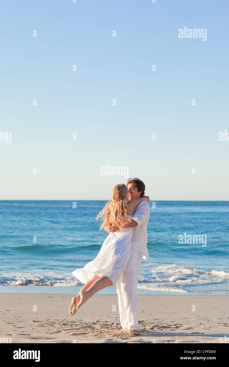 Couple turning at the beach Stock Photo - Alamy