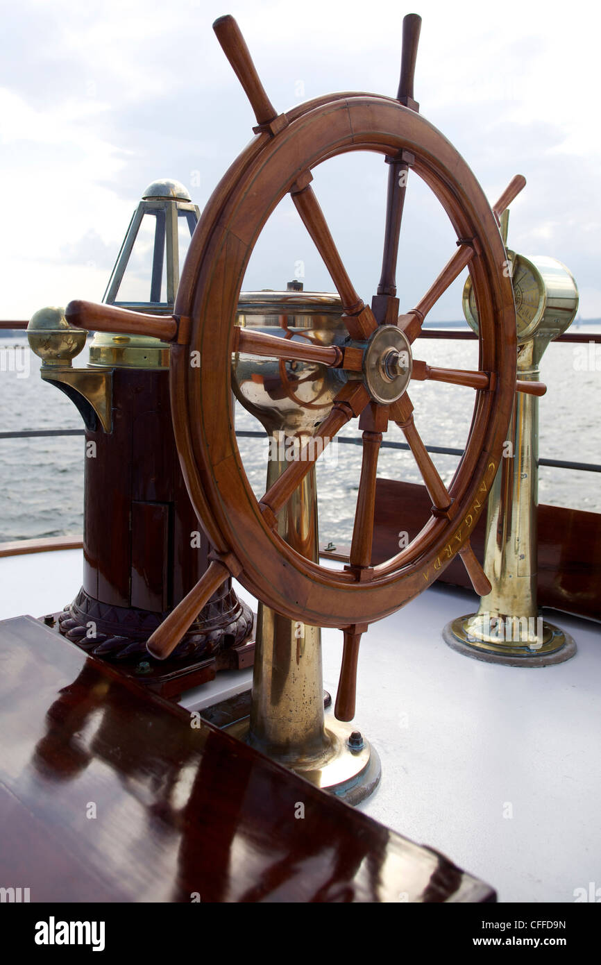 A ship's wheel and compass at the helm of a restored steamship at ...