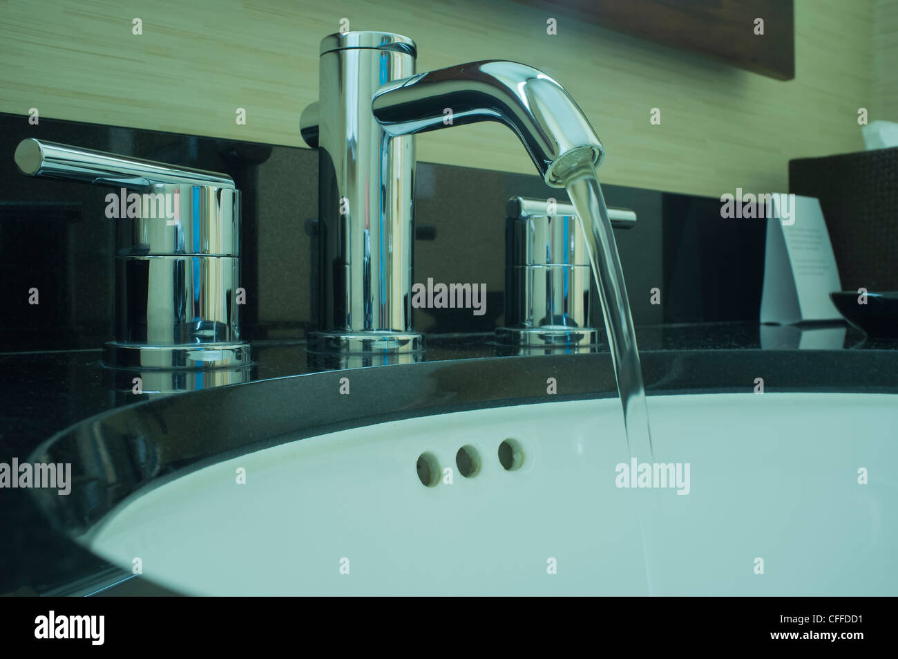 Running water bathroom faucet Stock Photo - Alamy