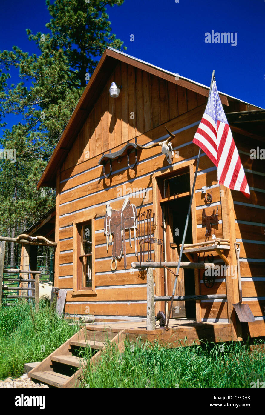 Western log cabin with American flag Stock Photo - Alamy