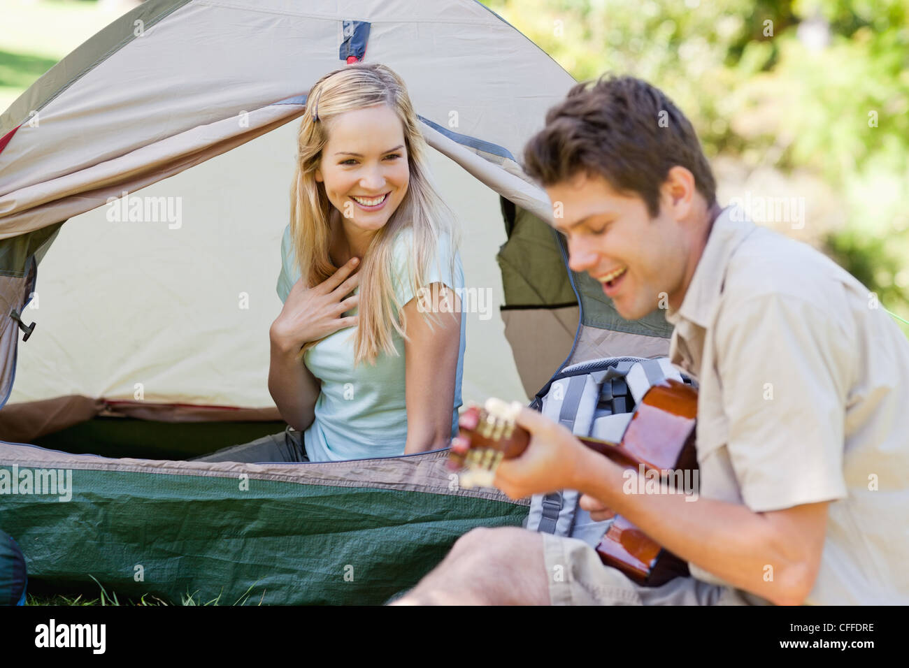 A man with a guitar plays and sings for his lover Stock Photo - Alamy