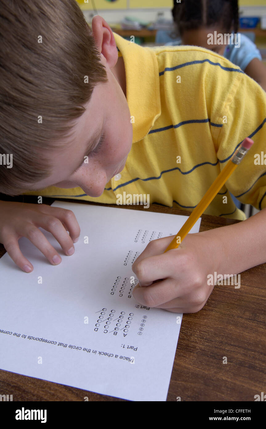 Boy Writes Exam in Class Stock Photo - Alamy