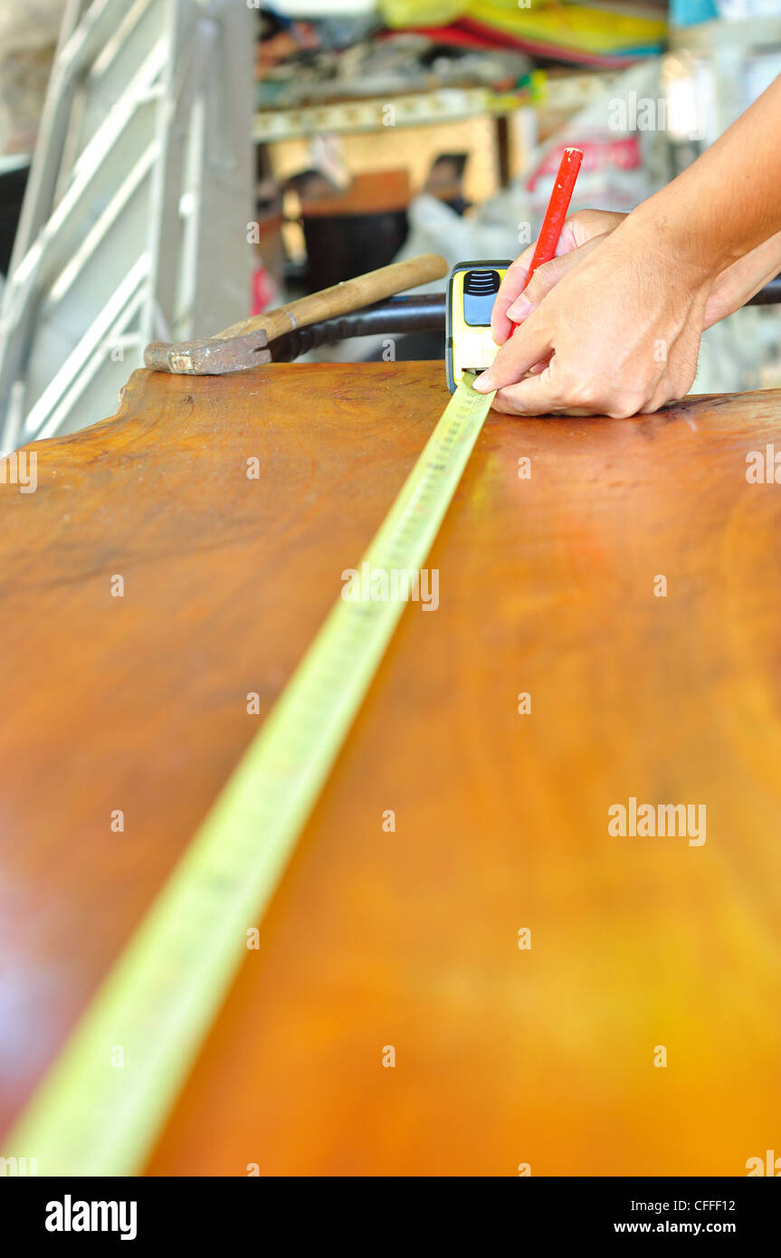 man working and measuring wood Stock Photo - Alamy
