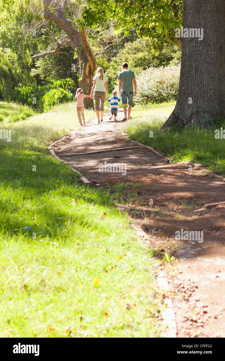 Family walking away from the camera down a path Stock Photo - Alamy