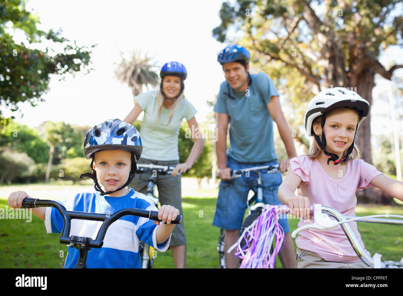 A happy family all about to go cycling Stock Photo - Alamy