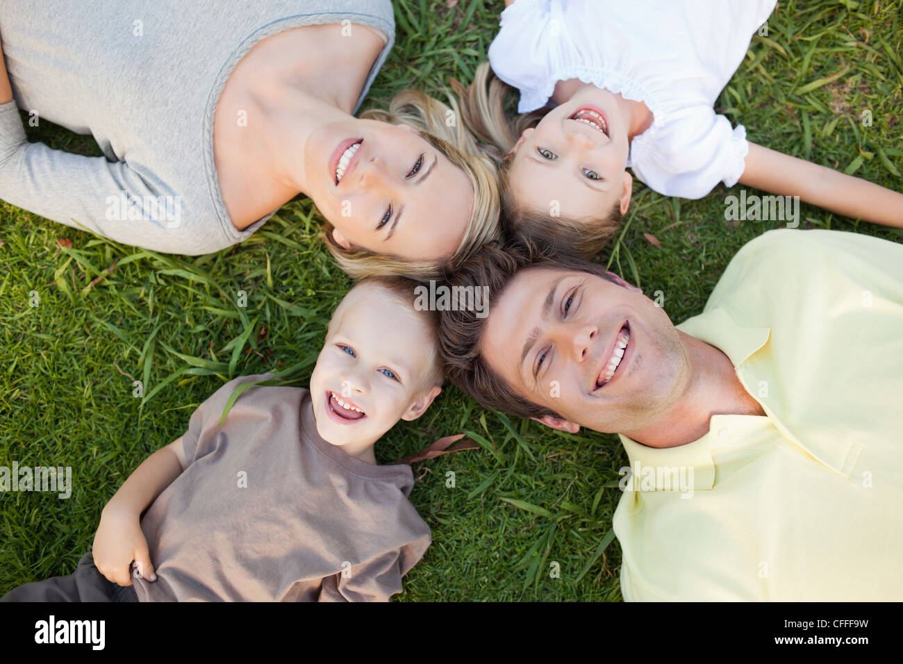 A smiling family lying on the ground together Stock Photo - Alamy