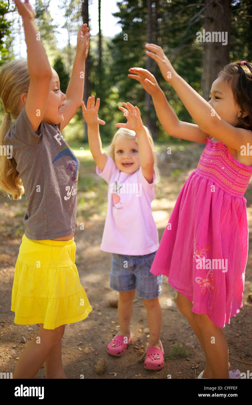 Three young girls play in the sun Stock Photo - Alamy