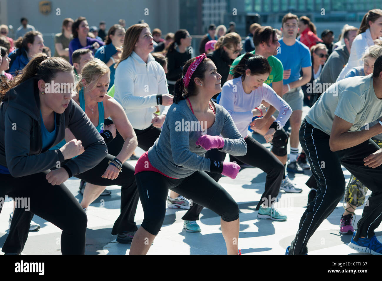 Exercisers participate in an exercise class on the flight deck of the ...