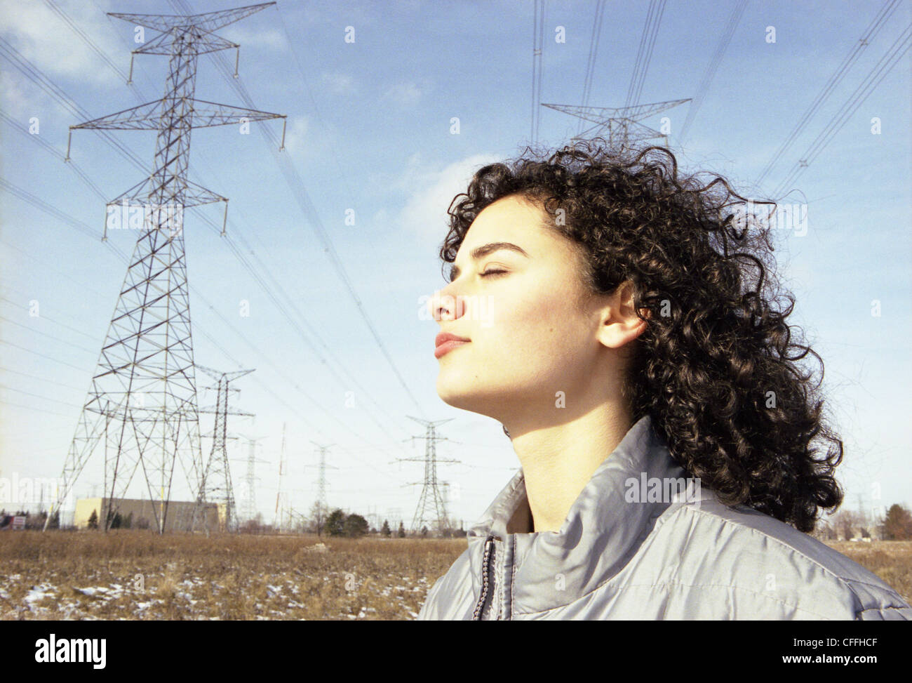 Girl Stands Beneath Power Lines and Towers Stock Photo - Alamy