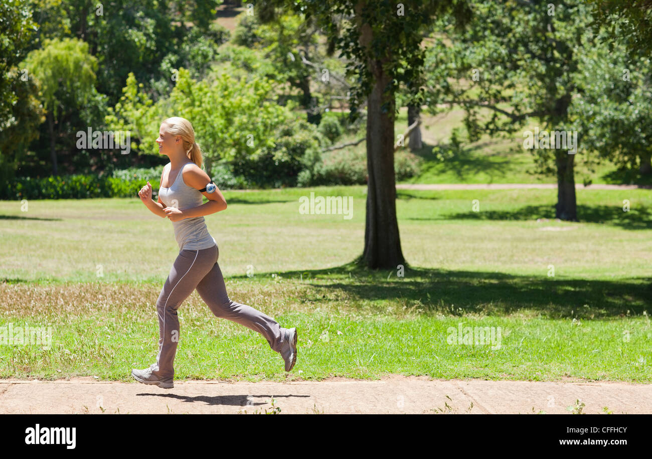 Side view of a jogging woman Stock Photo - Alamy