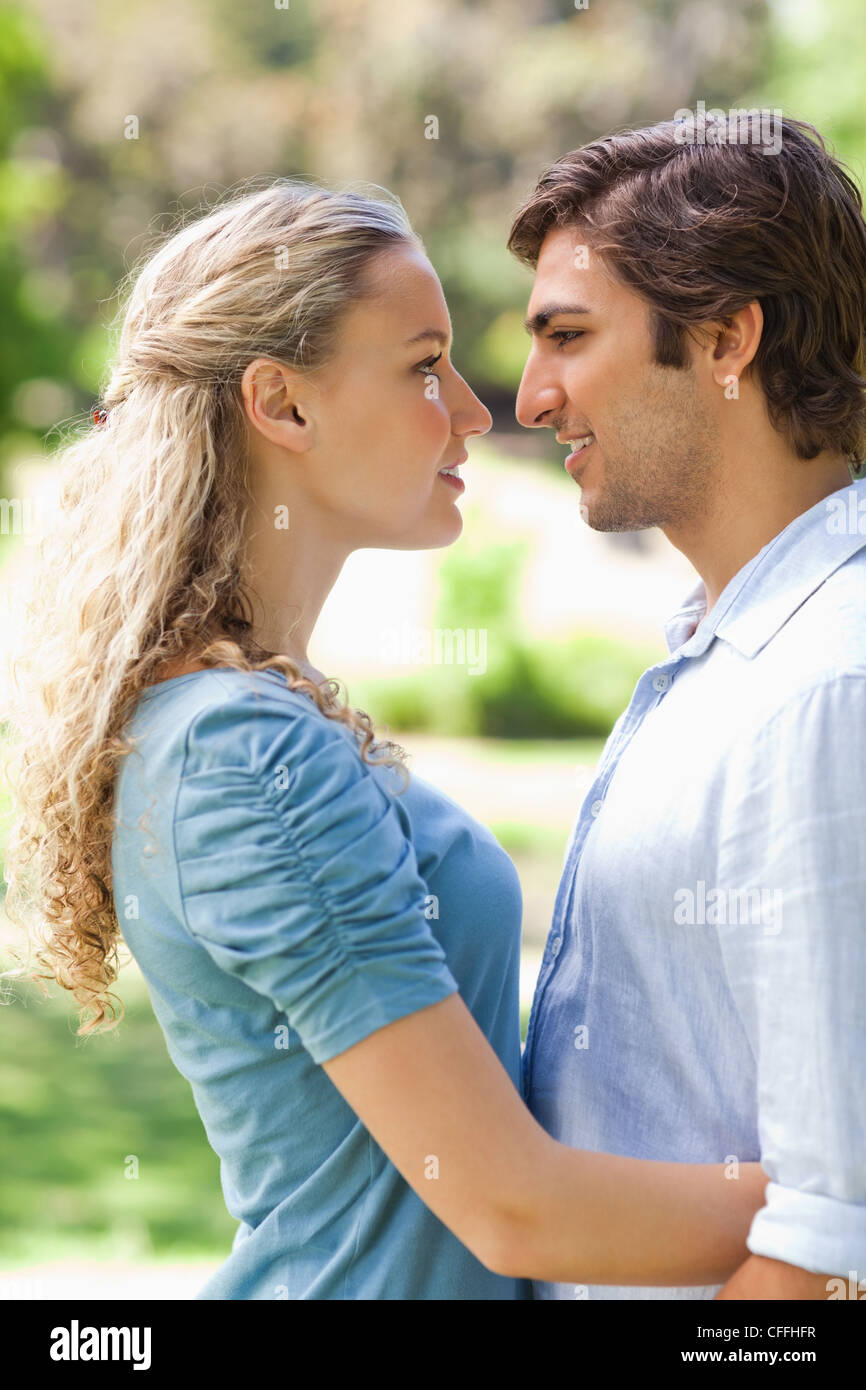 Side view of a couple standing in the park Stock Photo - Alamy