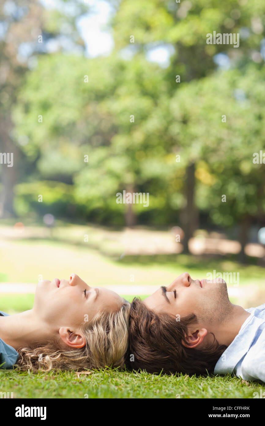 Woman taking nap on grass hi-res stock photography and images - Alamy
