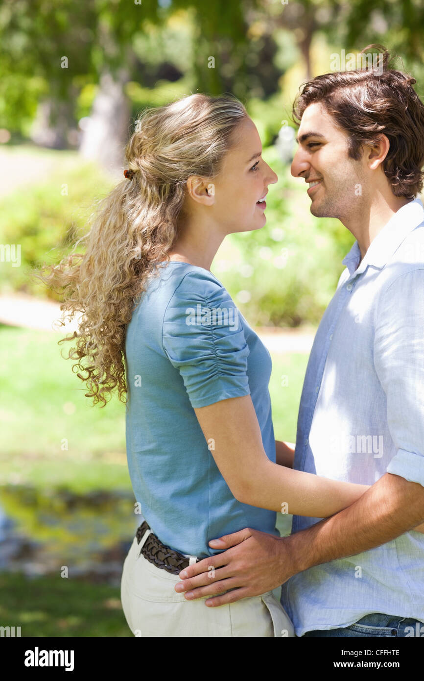 Side view of a couple hugging in the park Stock Photo - Alamy