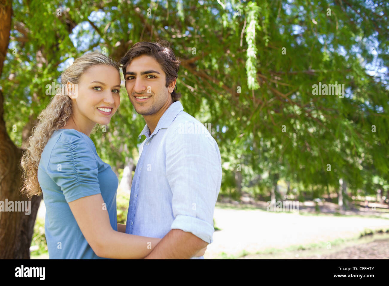Side view of an embracing couple in the park Stock Photo - Alamy