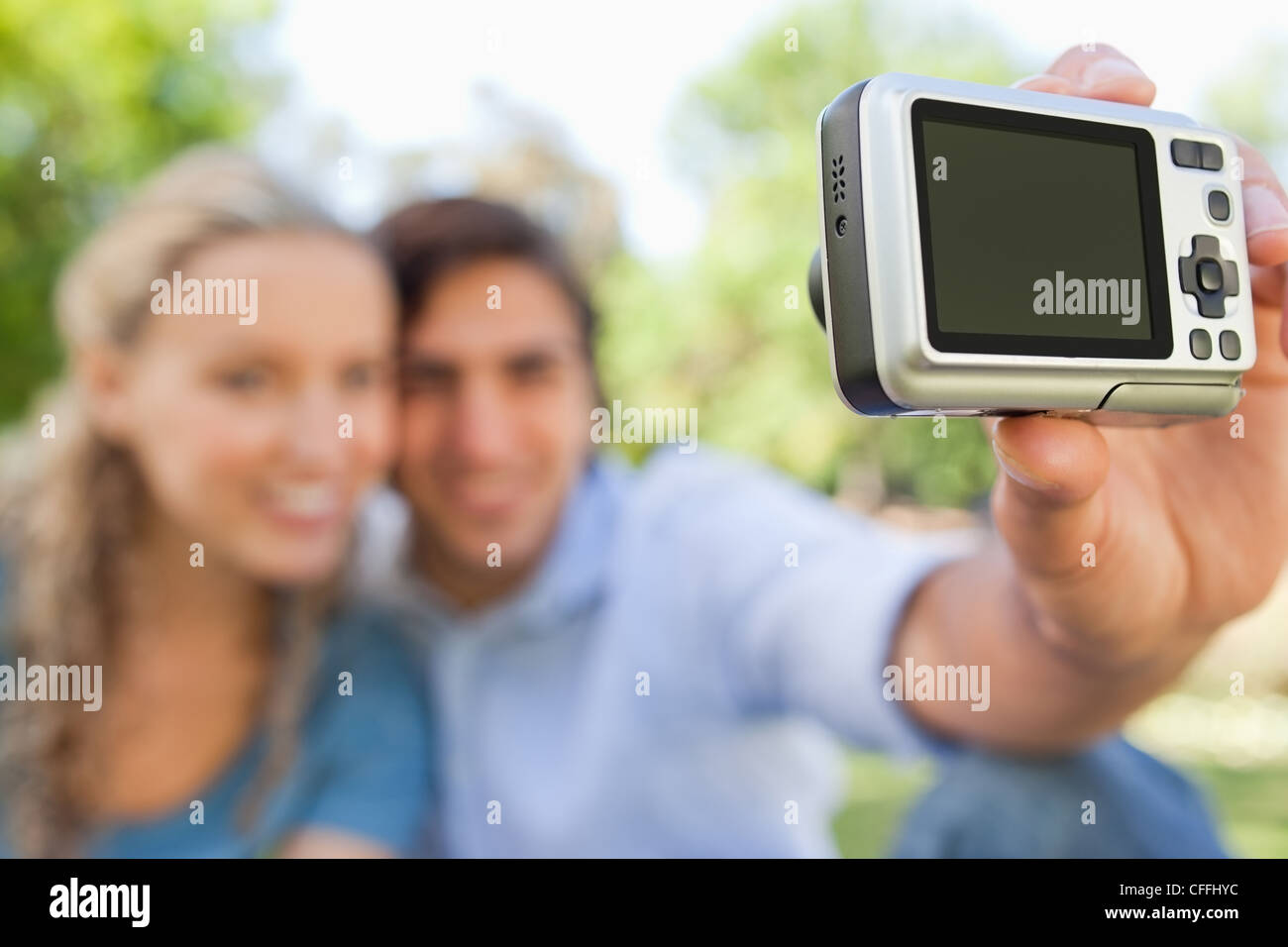 Camera being used to take a photo of a smiling couple Stock Photo - Alamy