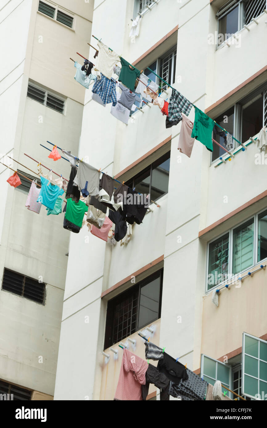 Washing lines hanging from apartment block windows . Singapore Stock ...