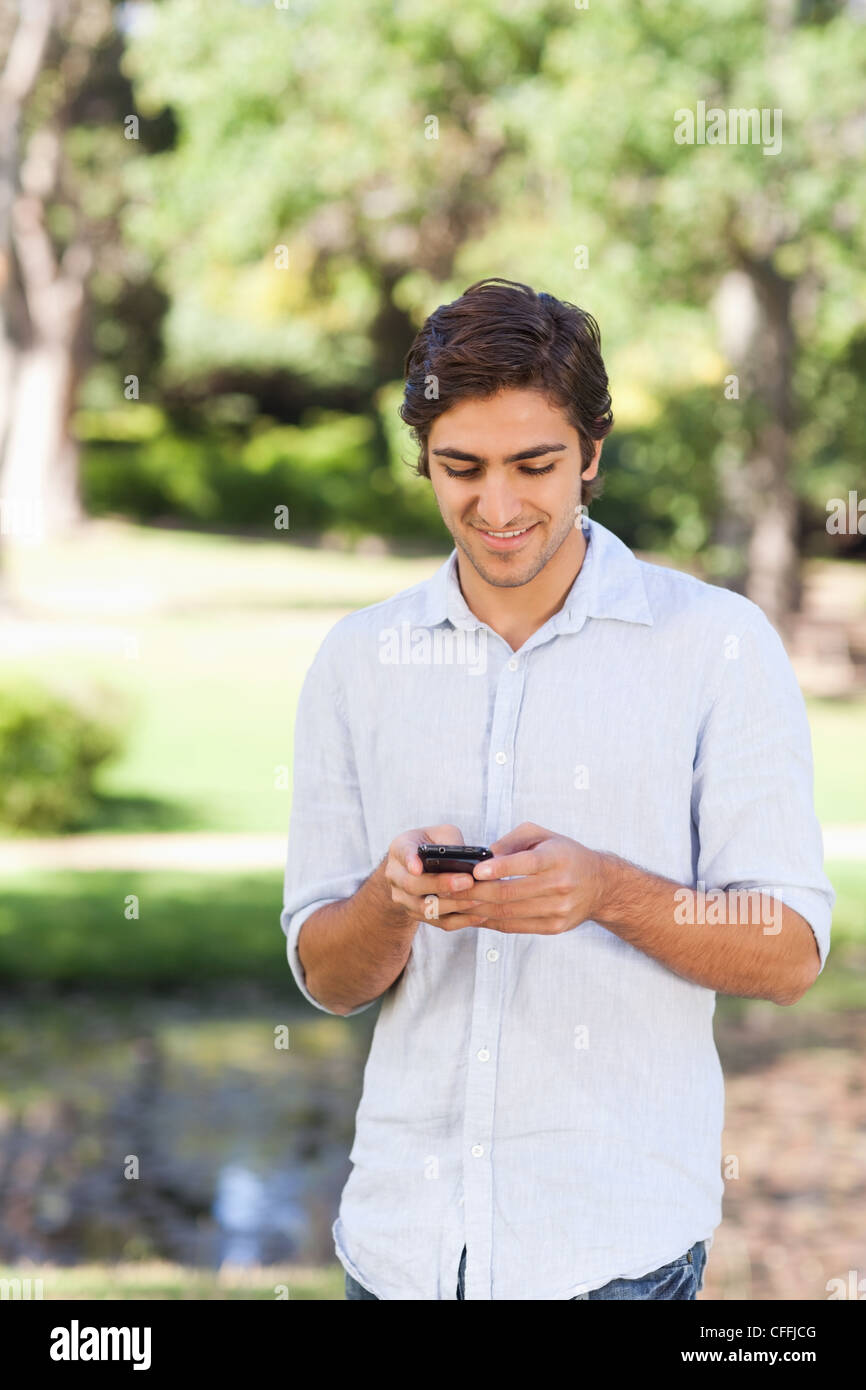 Smiling man using cellphone hi-res stock photography and images - Alamy