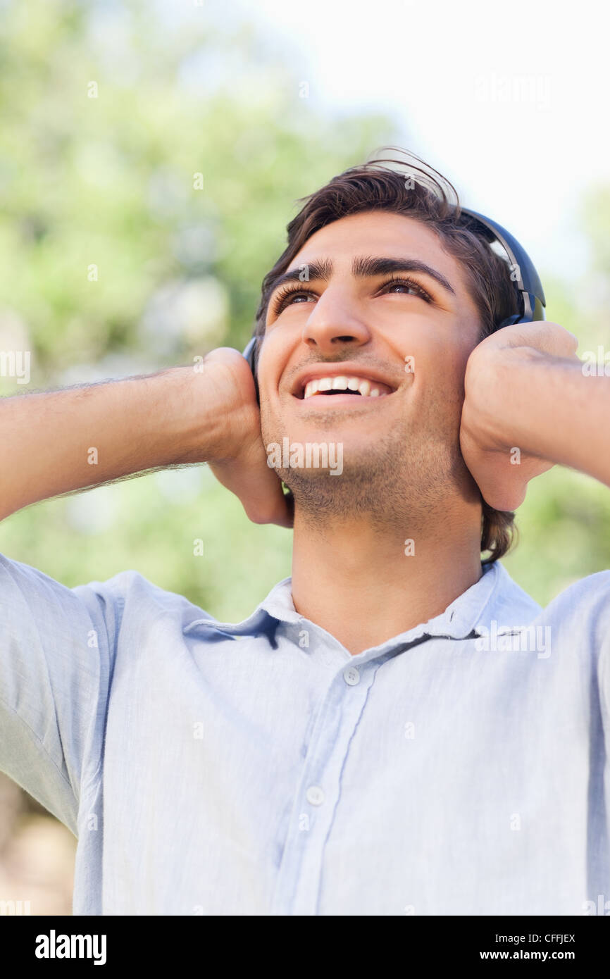 Smiling man with headphones listening to music Stock Photo - Alamy