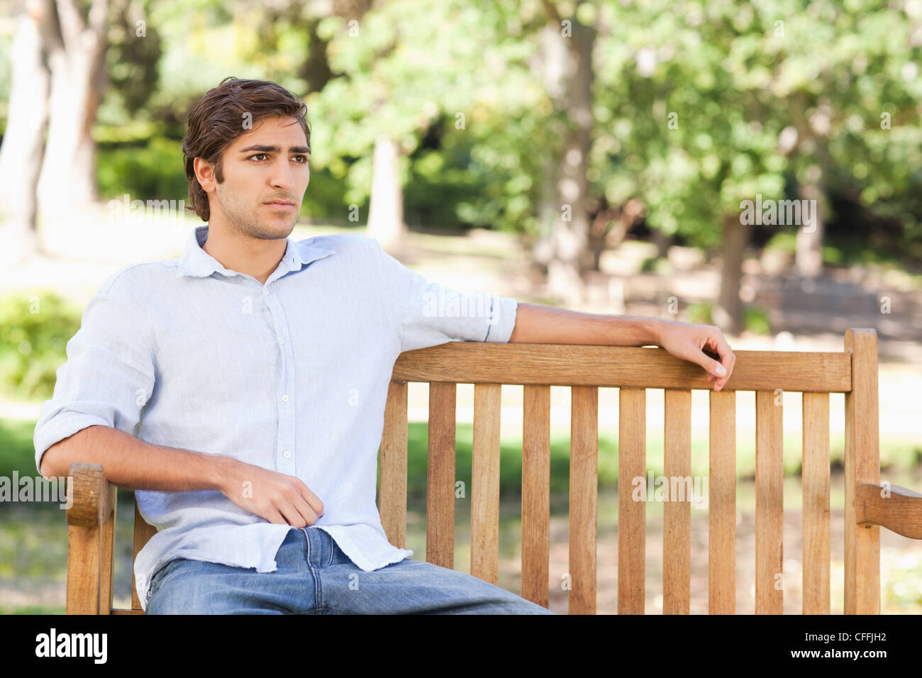 Man sitting on a bench Stock Photo - Alamy