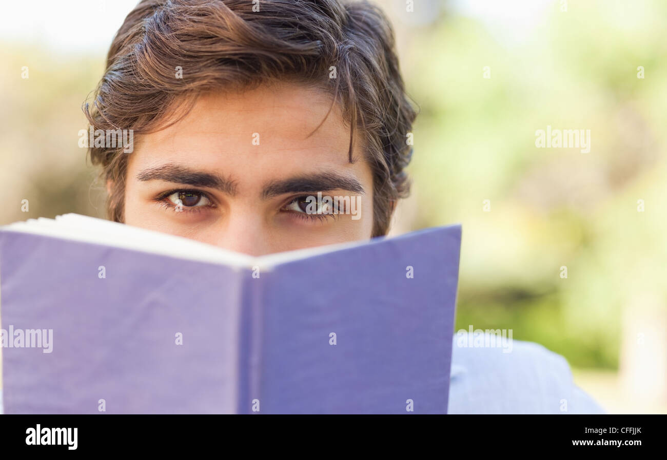 Man hiding behind book hi-res stock photography and images - Alamy