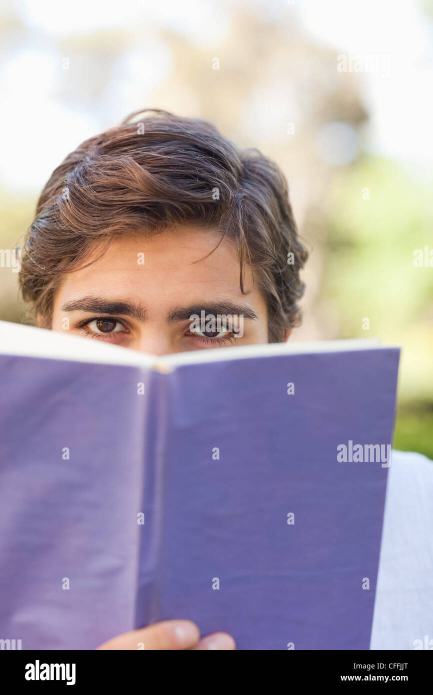 Man looking over his book Stock Photo - Alamy