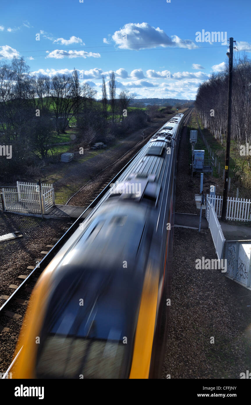 Passenger train crossing an unmanned pedestrian crossing Stock Photo ...