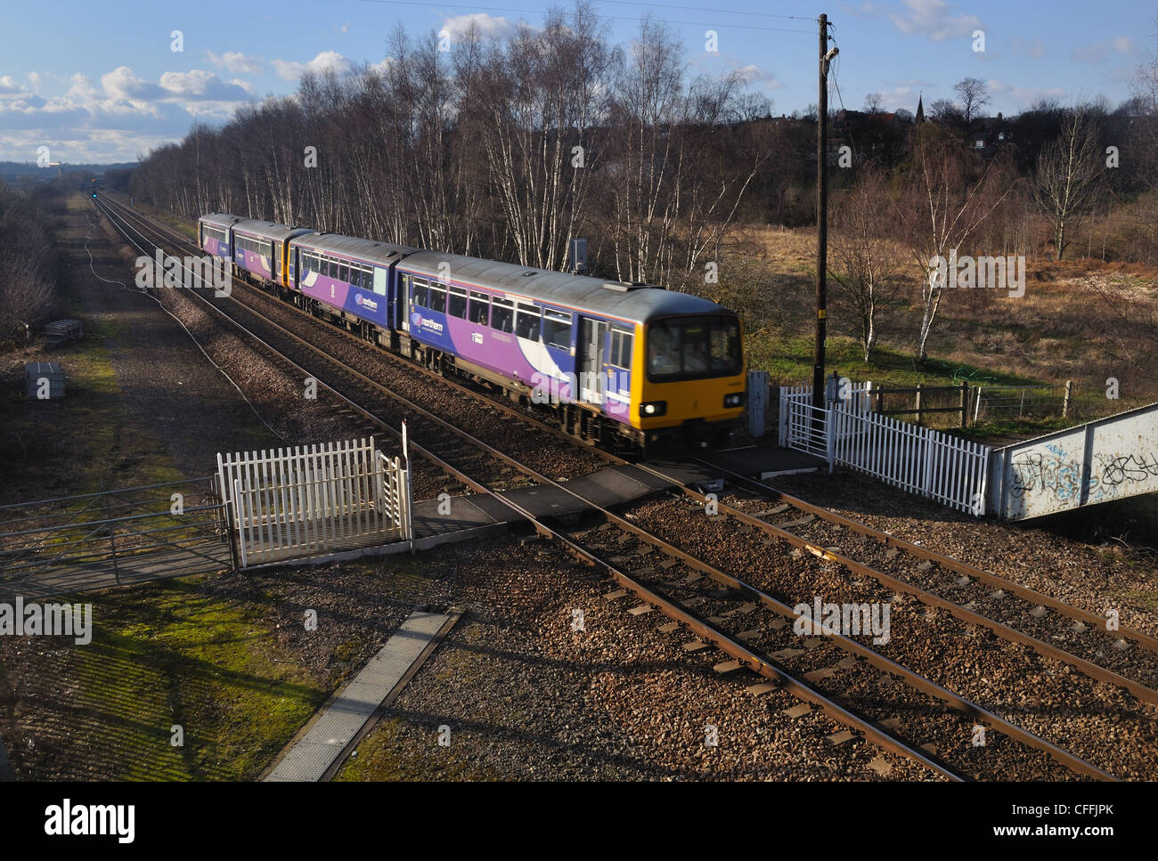 Passenger train crossing an unmanned pedestrian crossing Stock Photo ...