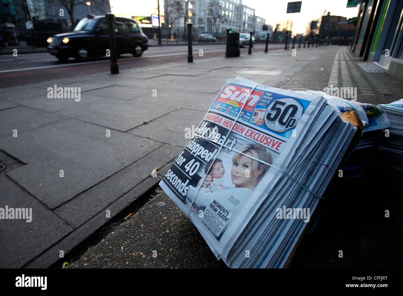 First copies of the new newspaper The Sun on Sunday are seen along side ...