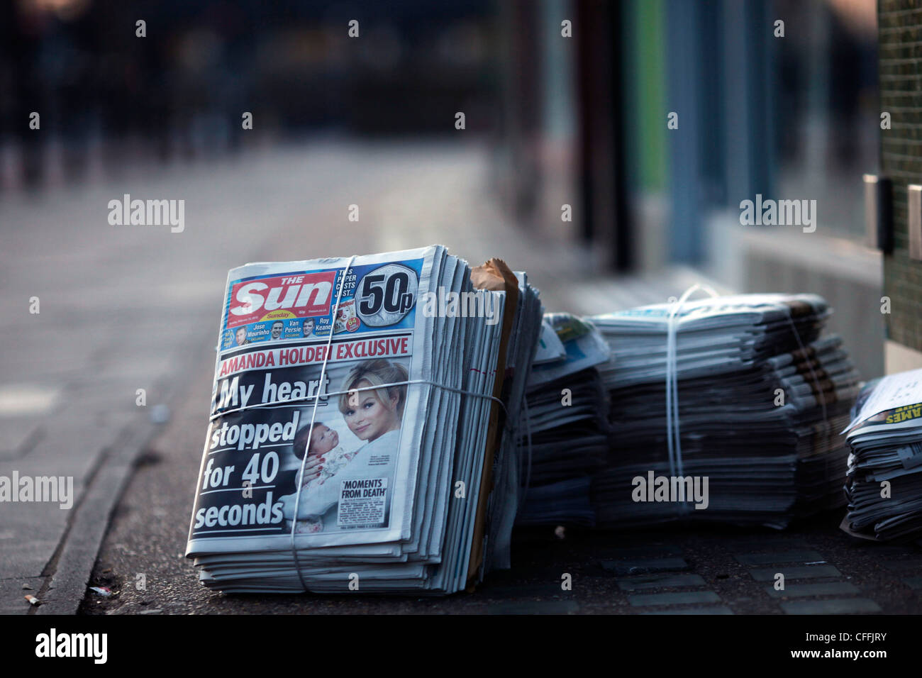 First copies of the new newspaper The Sun on Sunday are seen along side ...