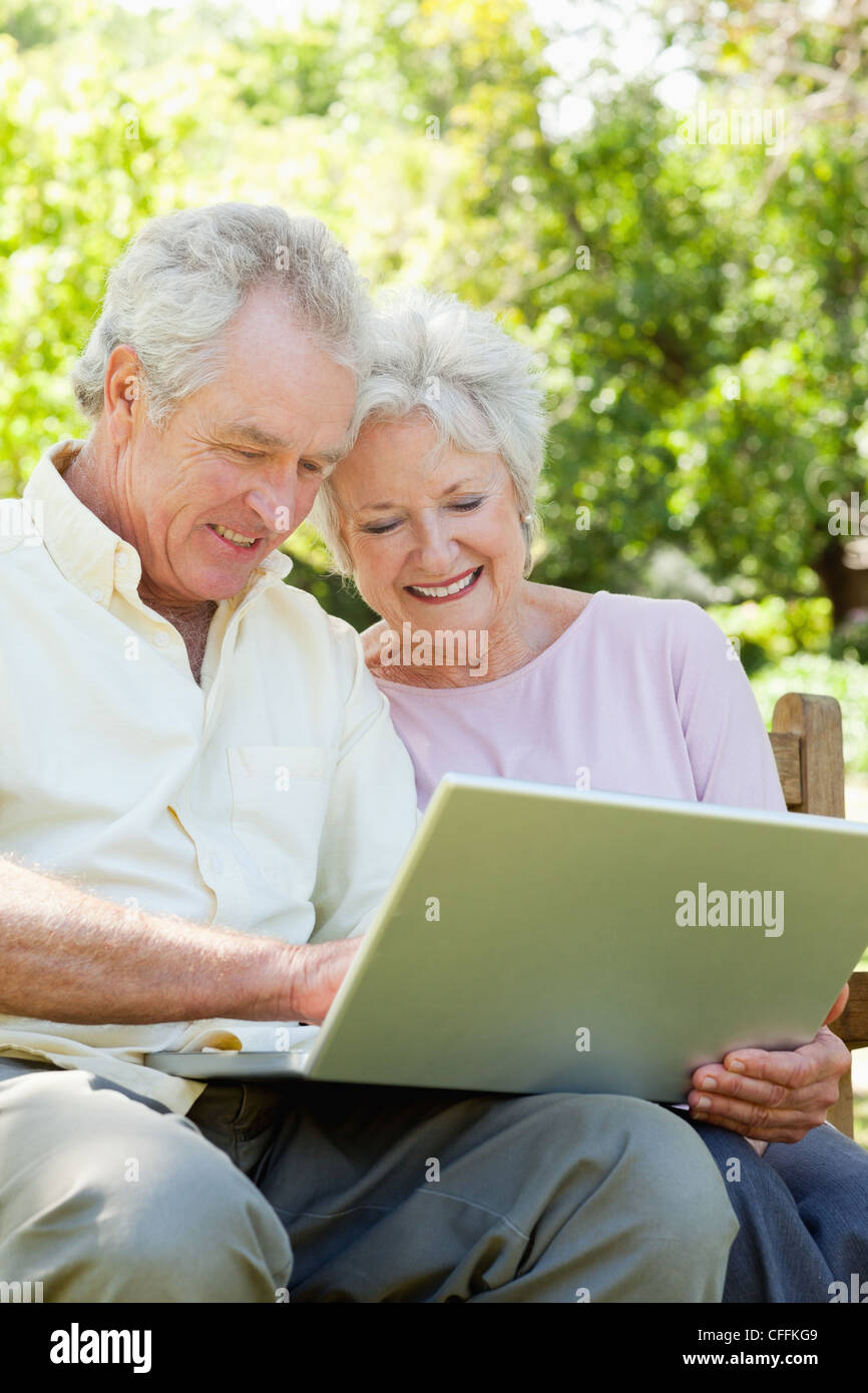 Couple sitting happily on grass hi-res stock photography and images - Alamy