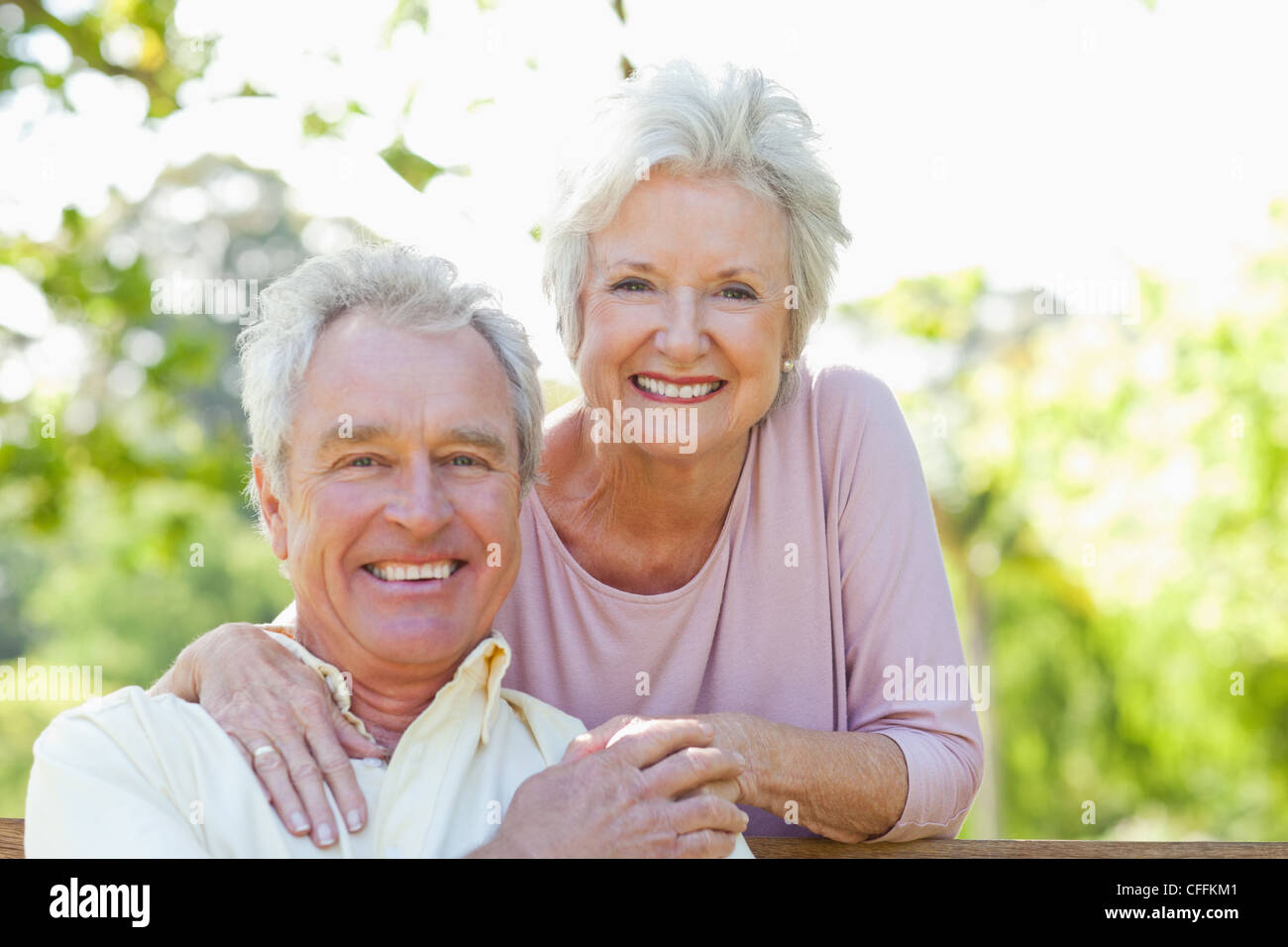 Two friends smiling while embracing each other Stock Photo - Alamy