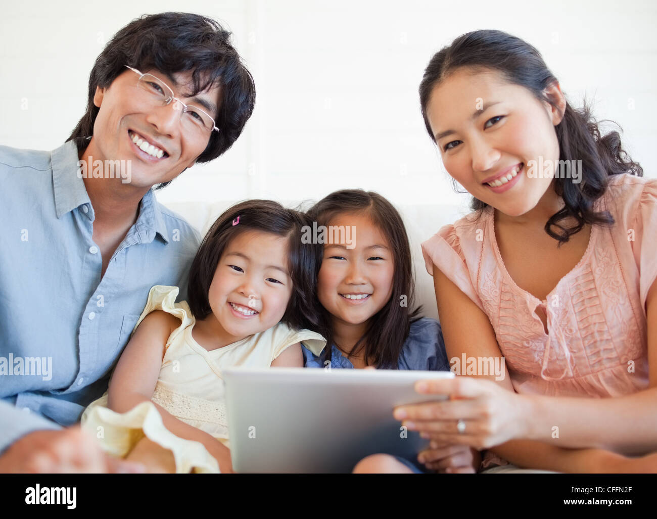 A happy family smiling and looking forward Stock Photo - Alamy
