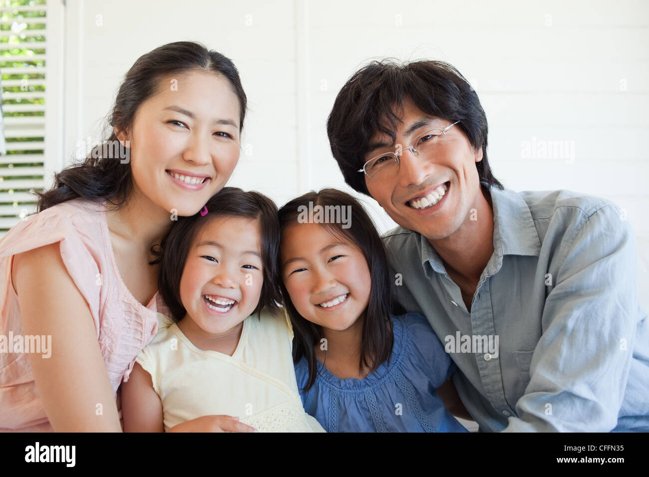 Smiling family all together on the couch Stock Photo - Alamy