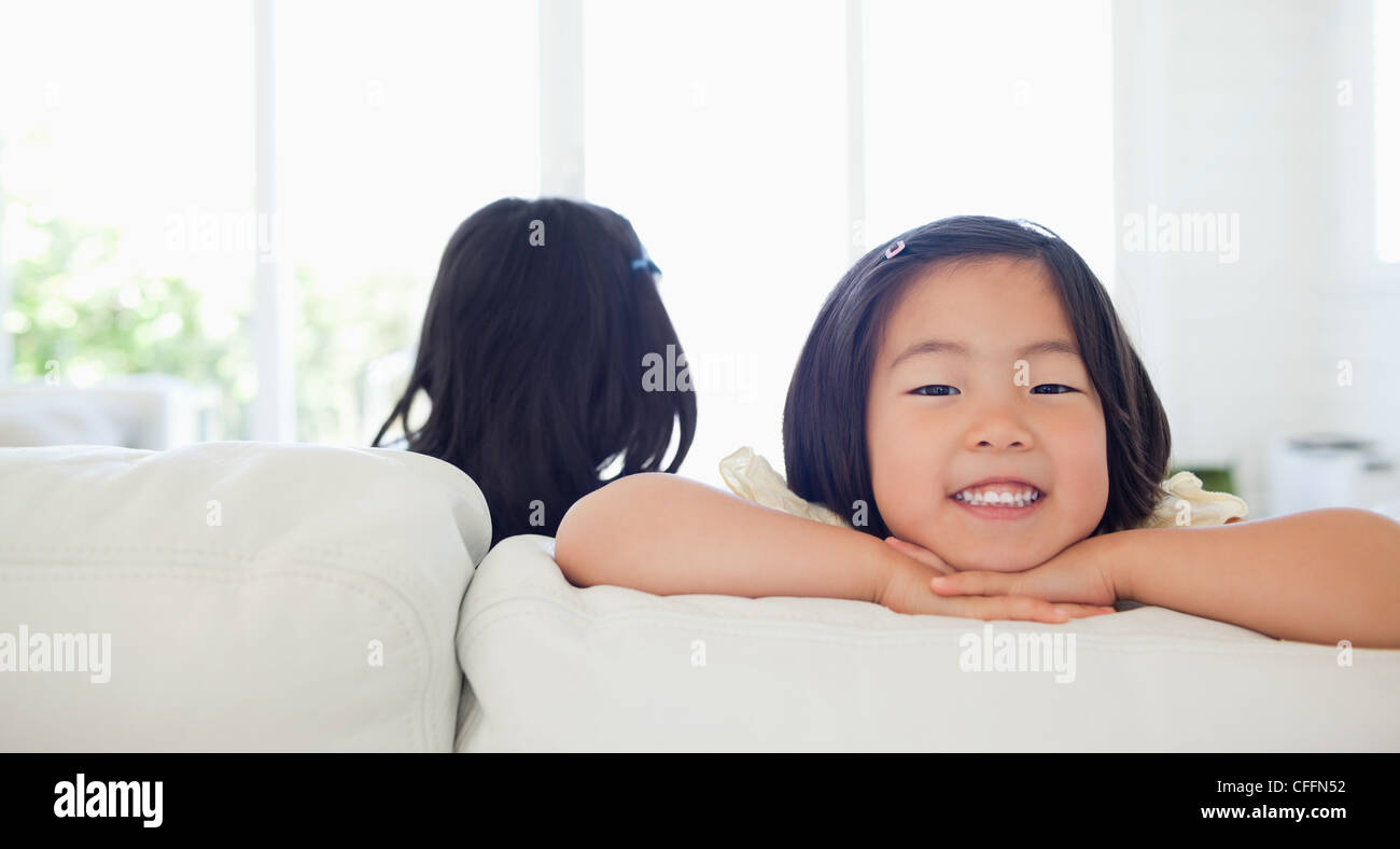 Smiling girl facing ahead with the other is facing away Stock Photo - Alamy