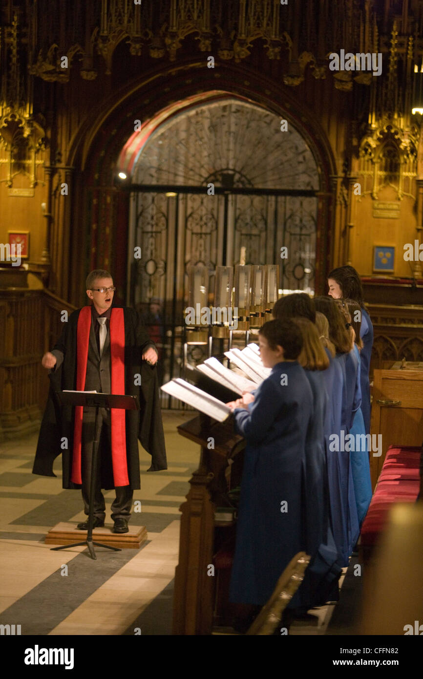 The choirmaster and choir during choir practice in York Minster, York ...