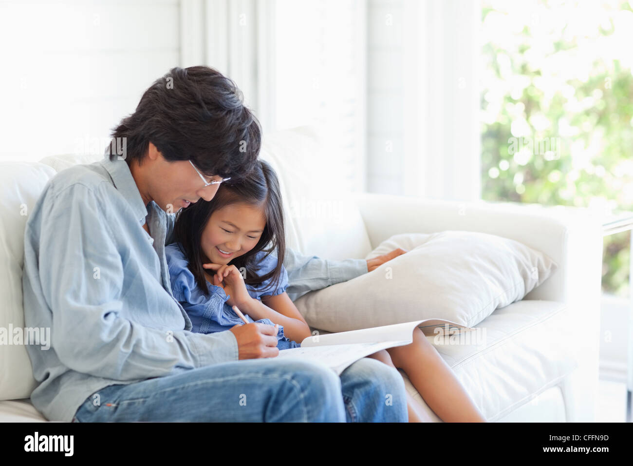 Asian family daughter doing homework hi-res stock photography and images - Alamy