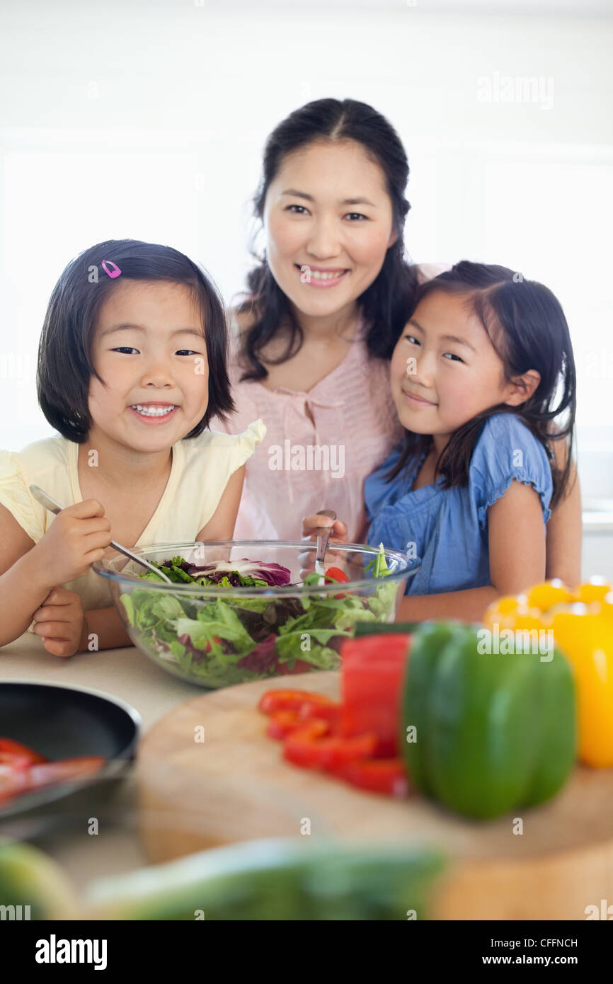 A smiling family make a salad in the kitchen Stock Photo - Alamy