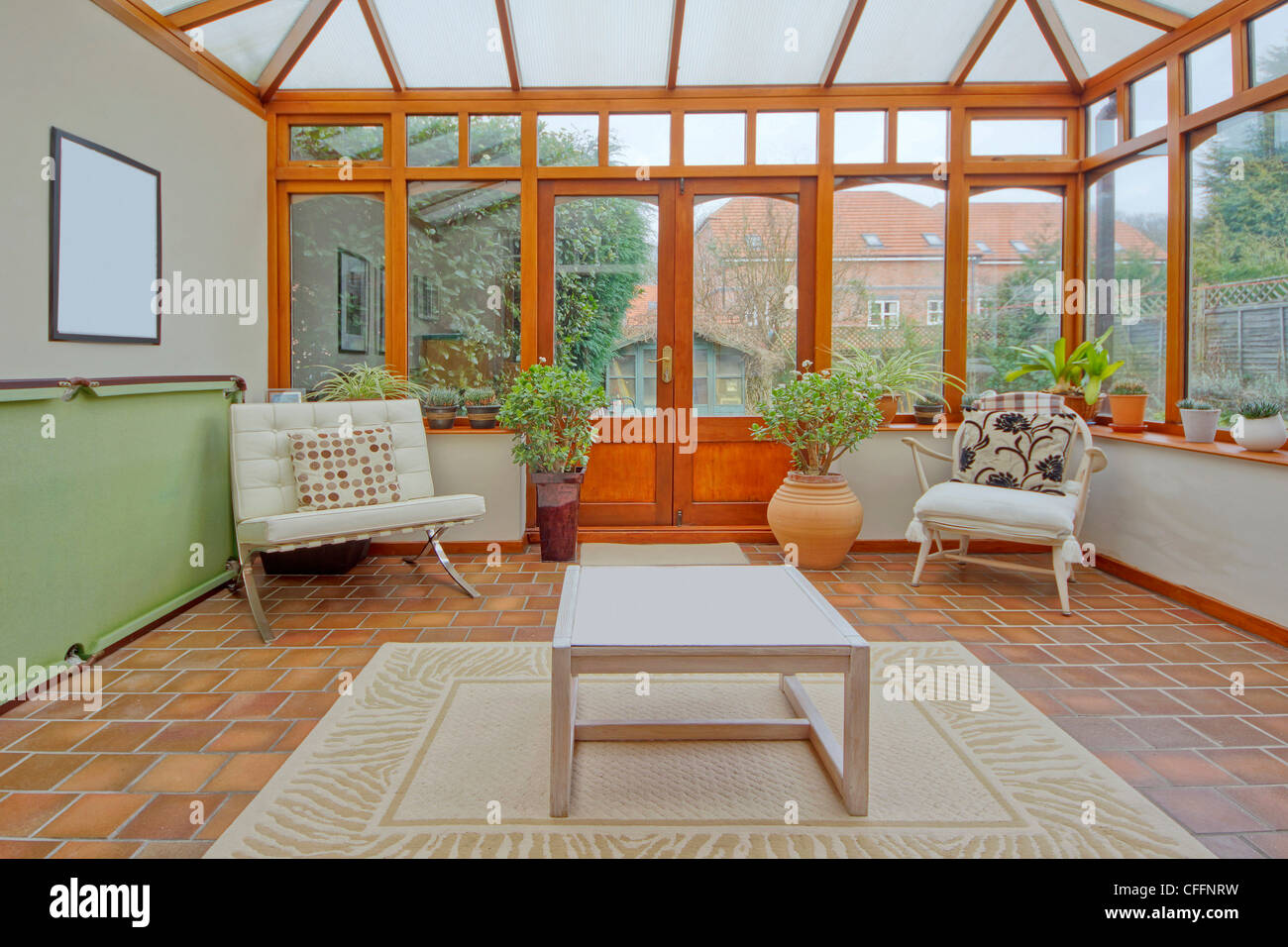 conservatory tables chairs plants room in house next to garden Stock ...