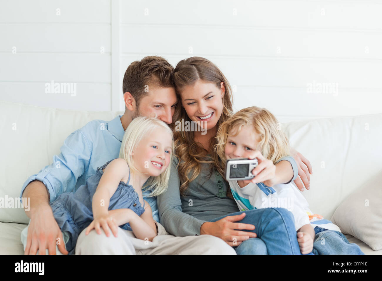 The family group in close on the couch for a pretty family photo Stock ...