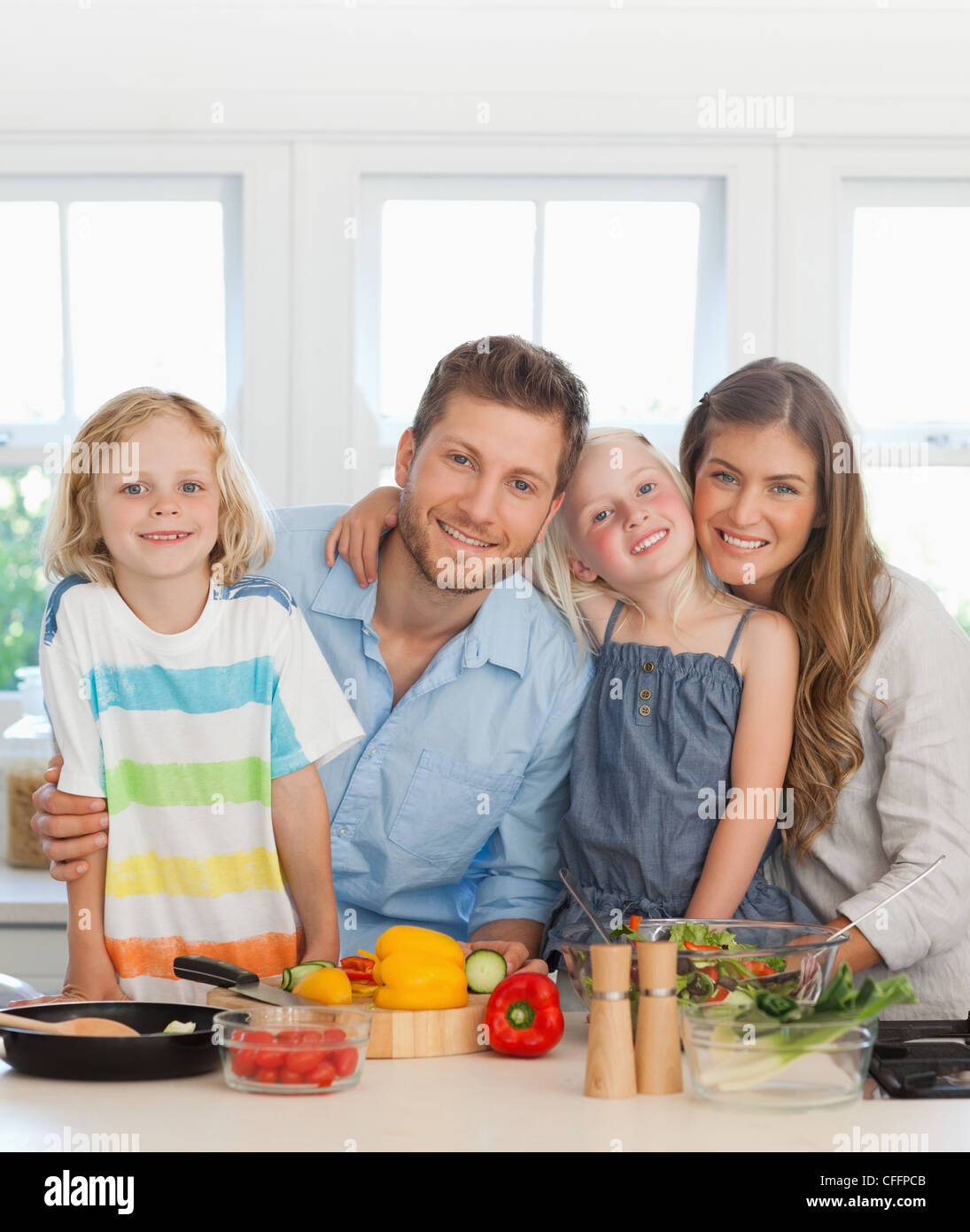 Family in the kitchen grouped together about to make some dinner Stock ...