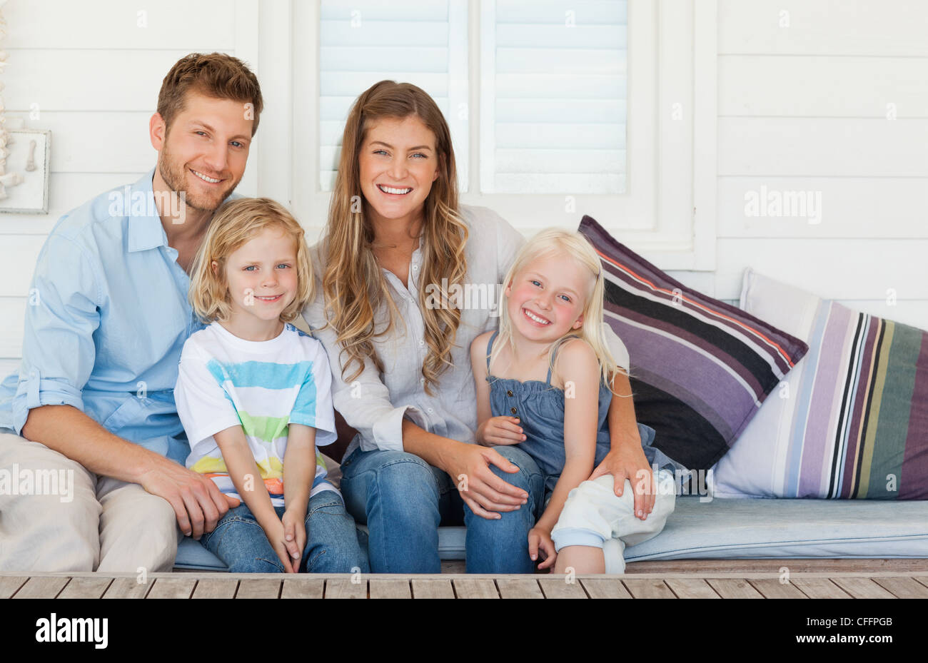 The entire family sit together on the seat Stock Photo - Alamy