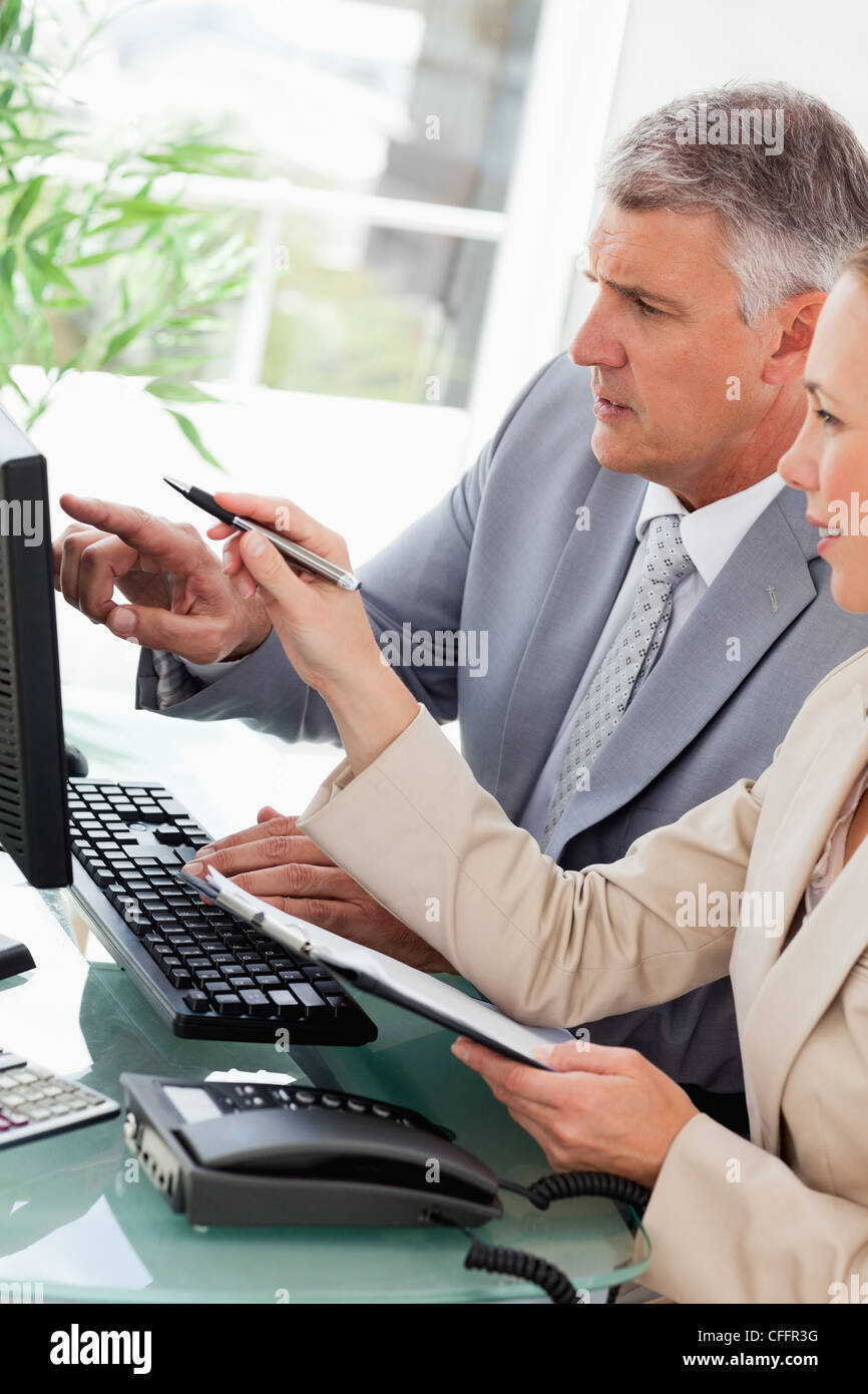 Concentrated man helping colleague hi-res stock photography and images ...