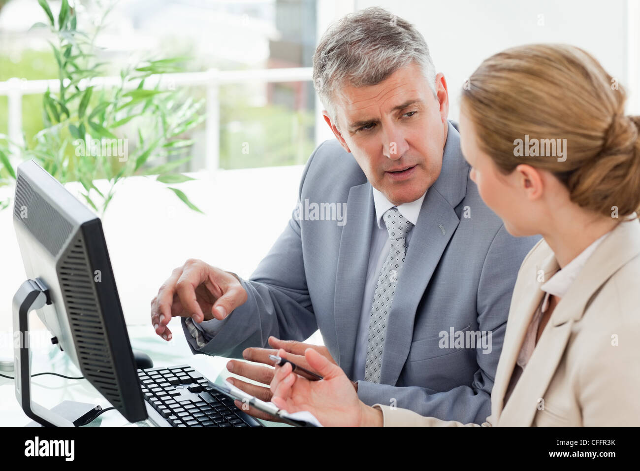 Businessman giving instructions to his secretary Stock Photo - Alamy