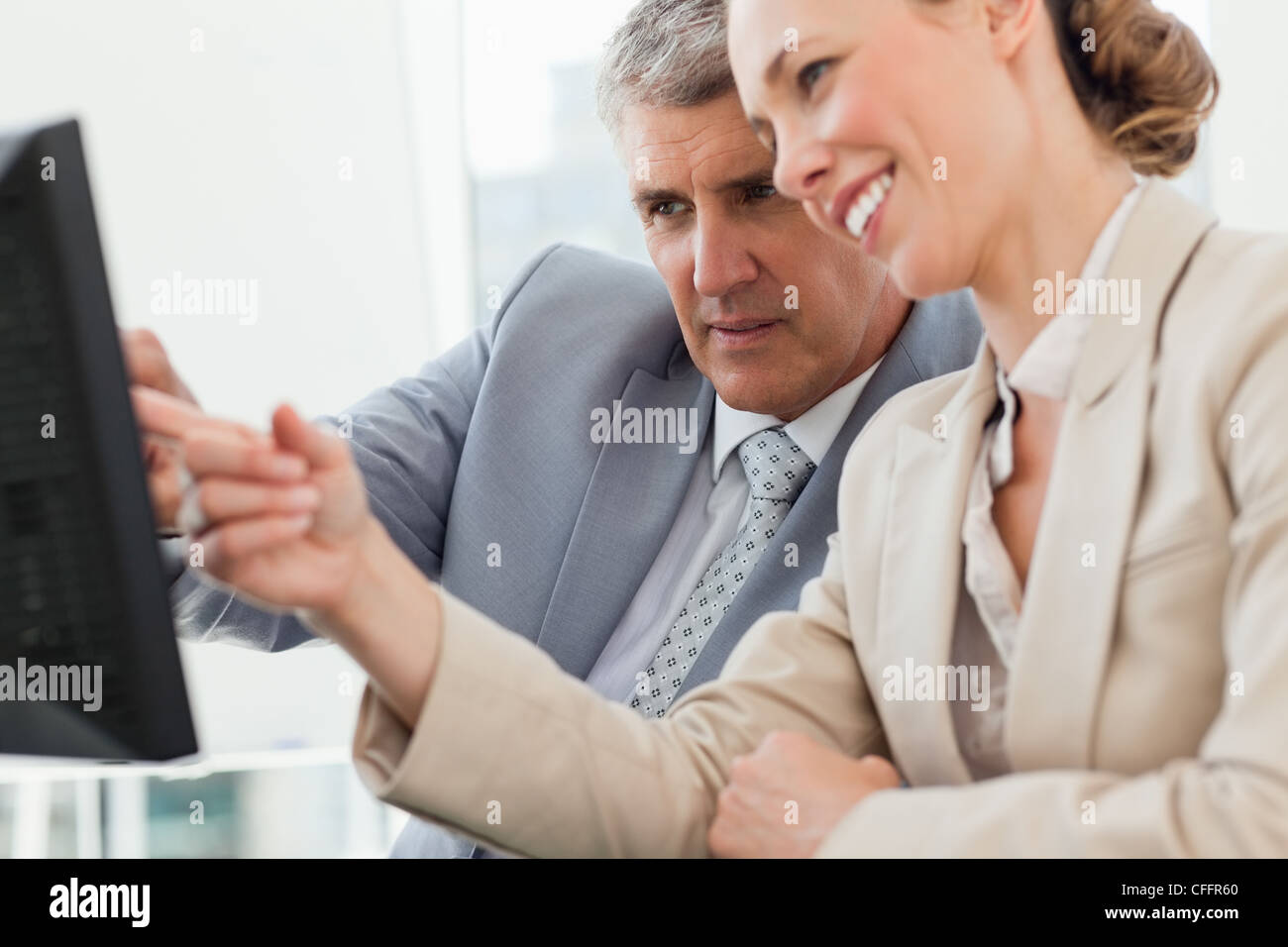Business people looking a computer screen Stock Photo - Alamy