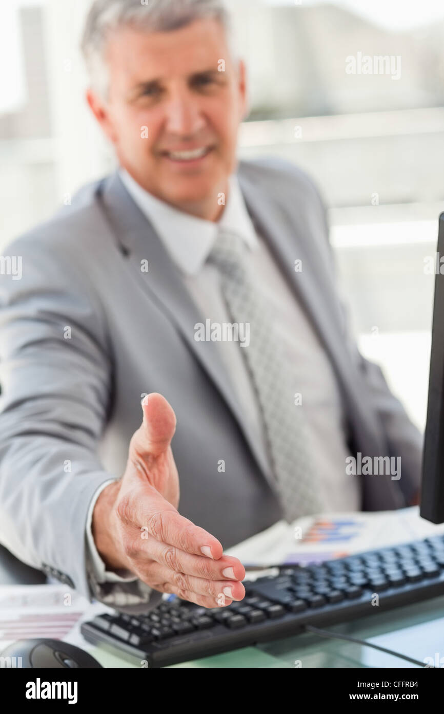 Boss holding out his hand Stock Photo - Alamy