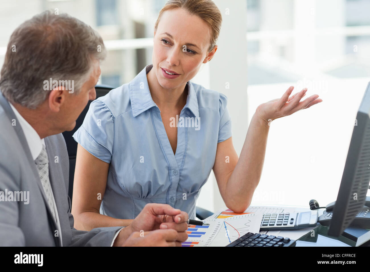 Employee explaining figures to her boss Stock Photo - Alamy